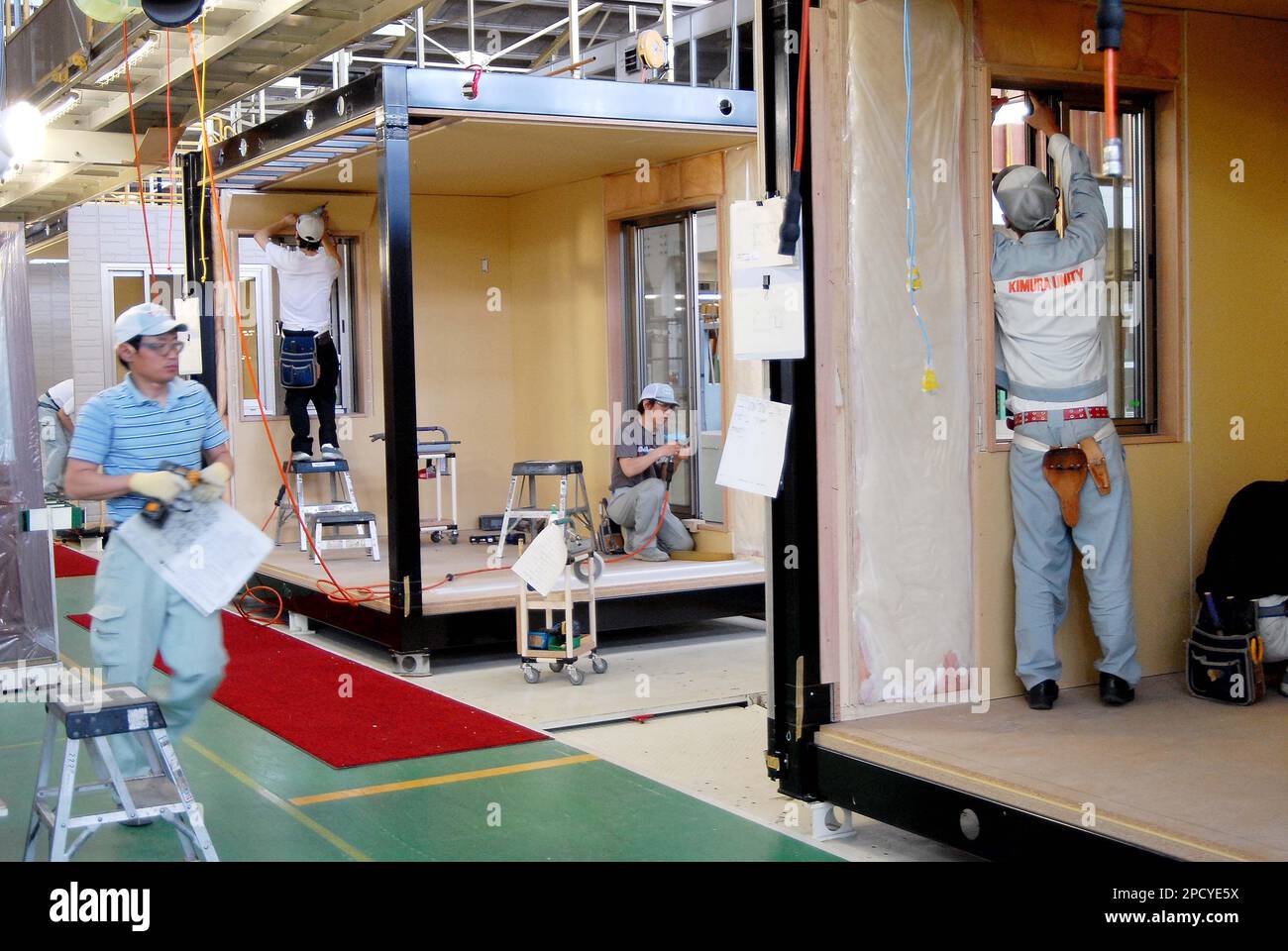 Workers are busy in cubicles that are parts of homes, complete with ...