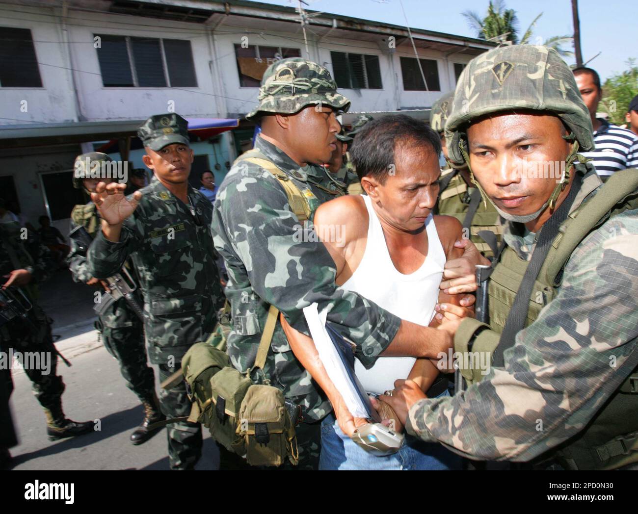 A discharged Philippine Navy personnel Edilberto Escarillo is led away ...