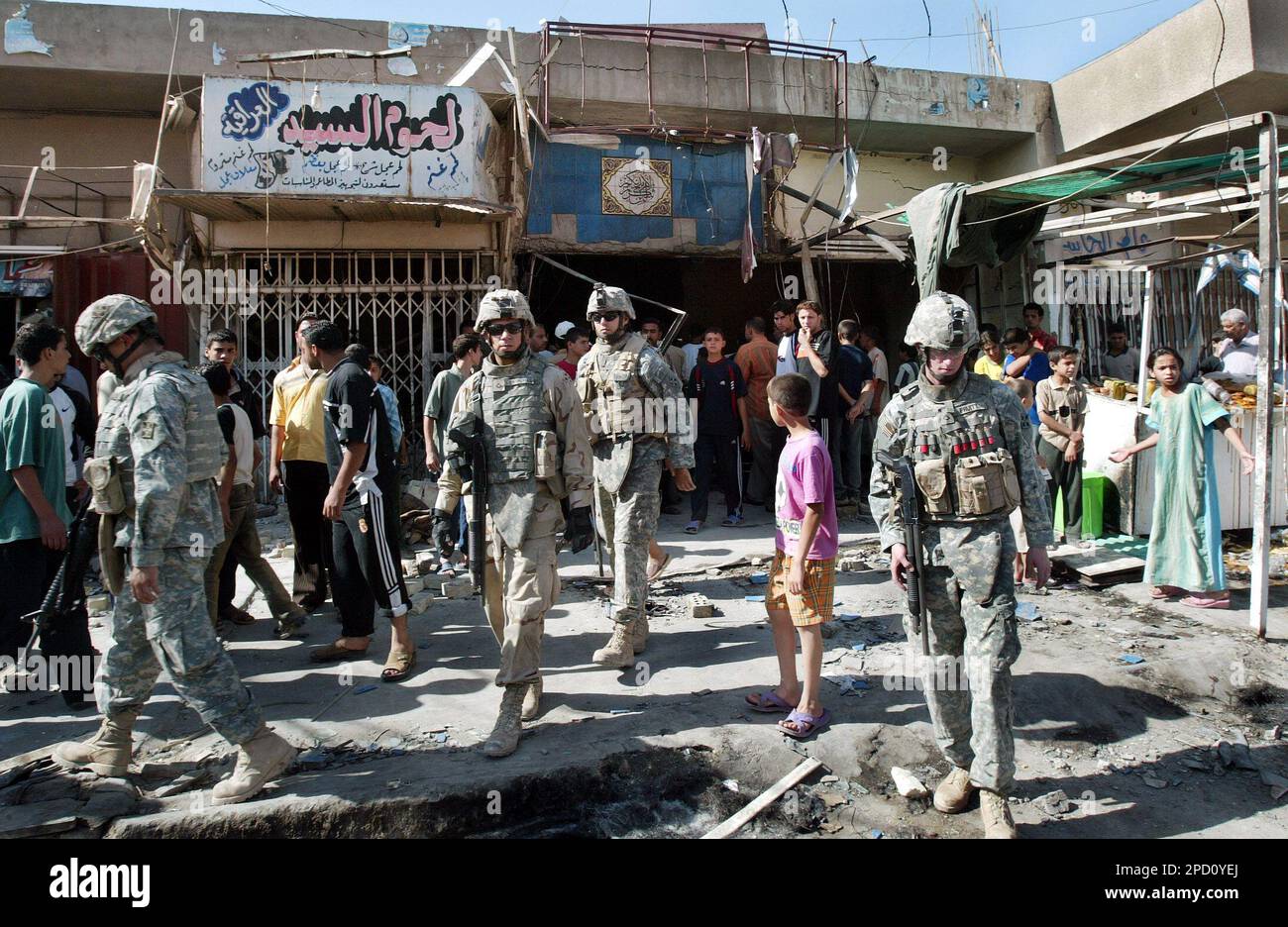 U.S. soldiers attend the scene Wednesday, May 31, 2006, after a bomb ...