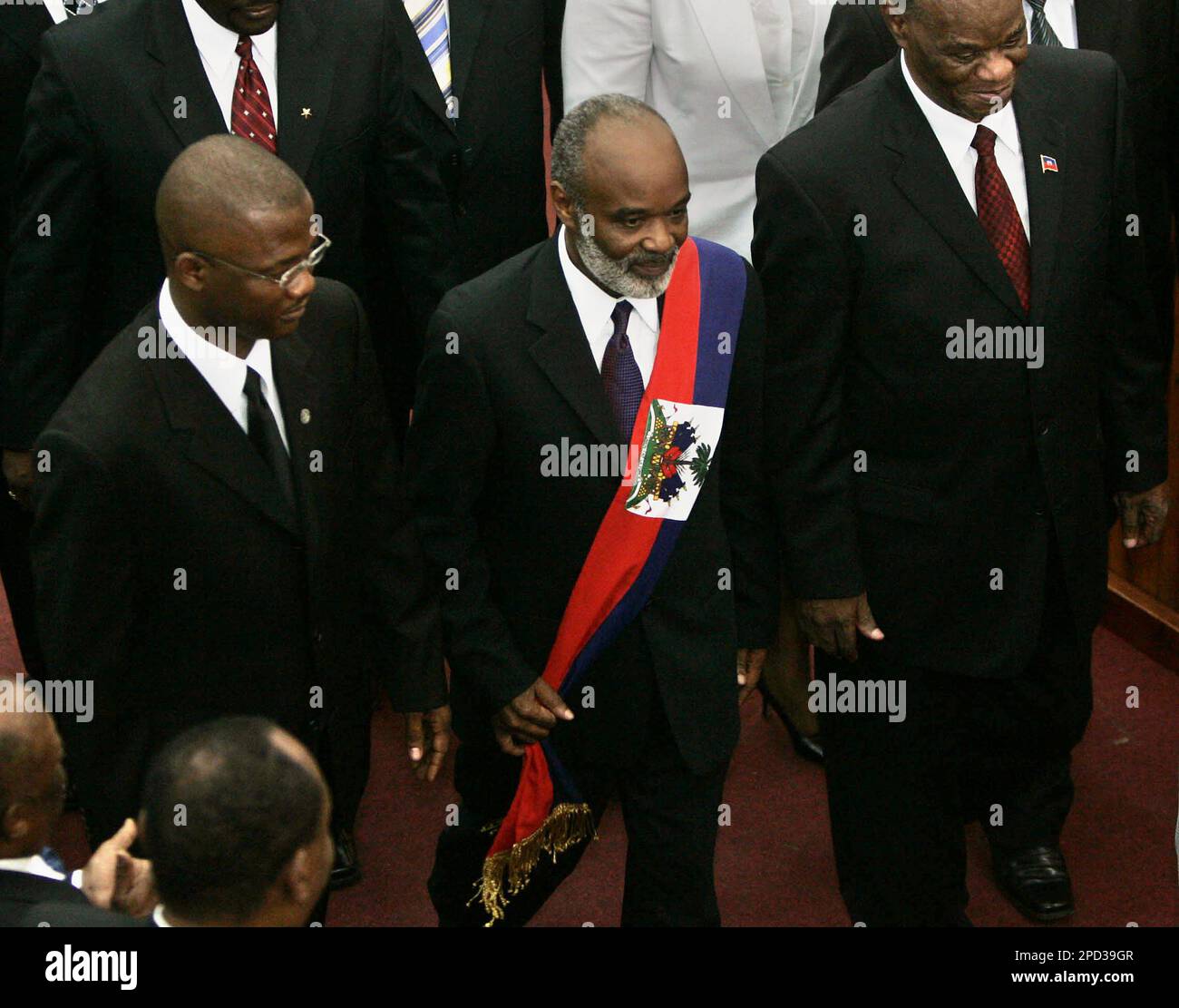 Haiti's newly-sworn in President Rene Preval, center, is escorted by ...