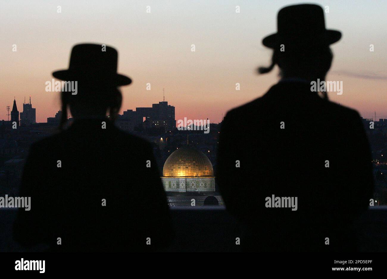 Ultra-Orthodox Jewish men looks towards the Dome of the Rock Mosque ...
