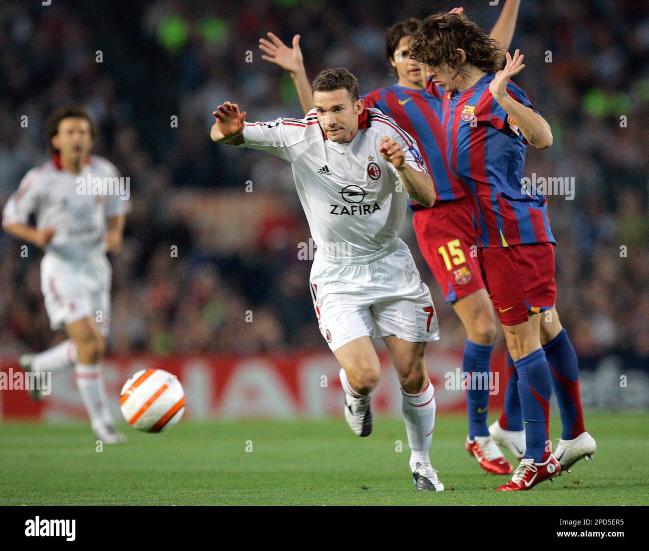 AC Milan's Andriy Shevchenko, left, takes the ball past Barcelona's ...