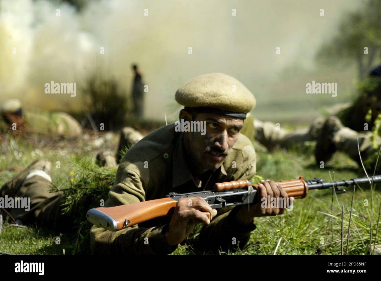 Jammu and Kashmir police constables crawl during combat battle training ...
