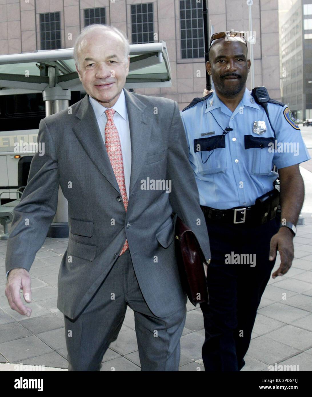 Enron founder Ken Lay, left, is escorted by a police officer into the ...