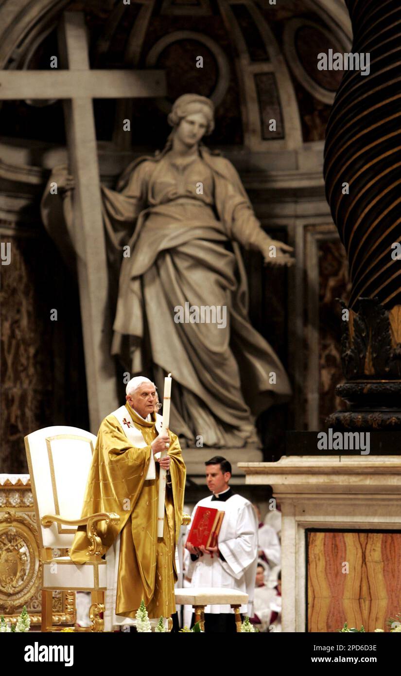 Pope Benedict XVI holds a candle during the Easter vigil Mass in St ...