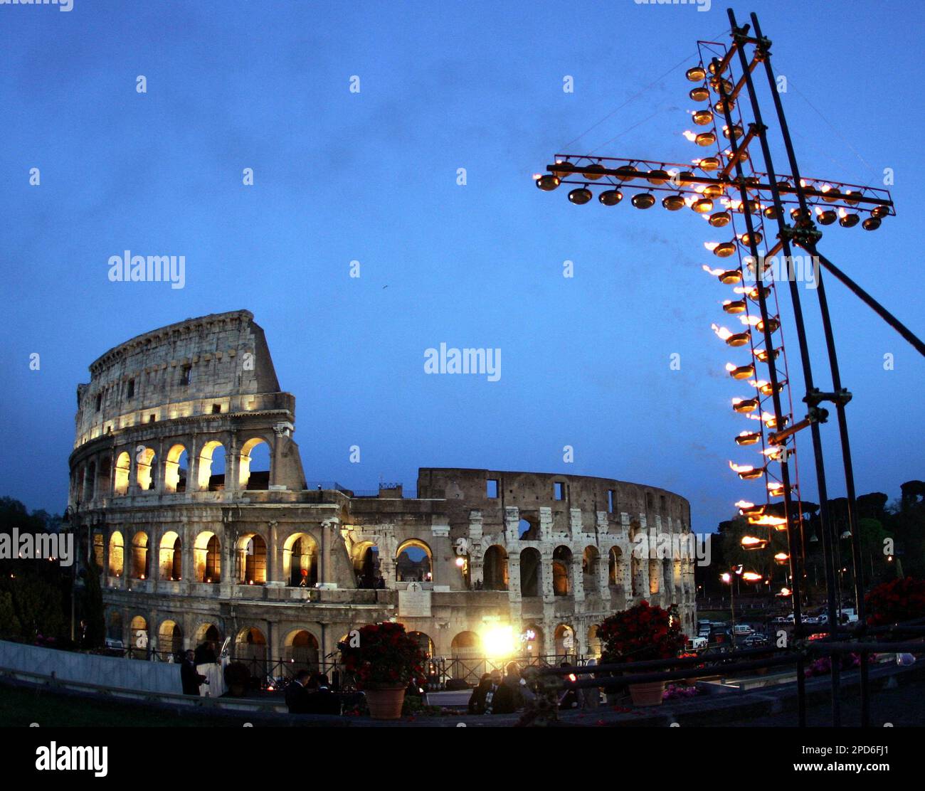 A cross is seen in front of the Colosseum prior to the start of the Via ...