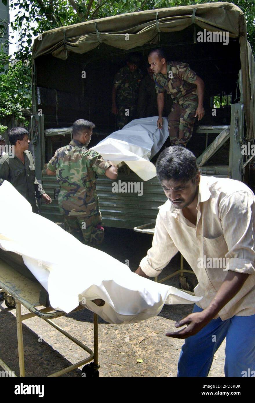 Sri Lankan government soldiers bring the bodies of fellow soldiers who died in an explosion in ...