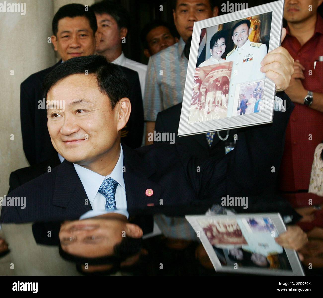 Thailand's caretaker Prime Minister Thaksin Shinawatra shows his family ...