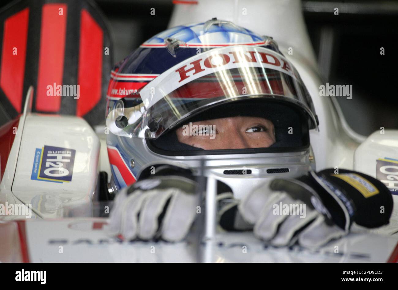 Japanese Super Aguri F1 driver Takuma Sato gasture as he sits in the ...