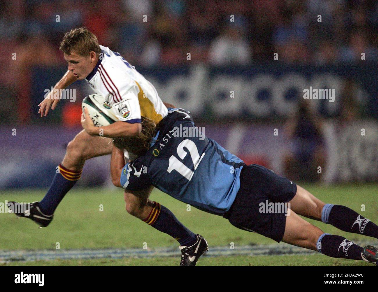 South Africa's Bulls Wynand Olivier, right, tackles New Zealand's ...