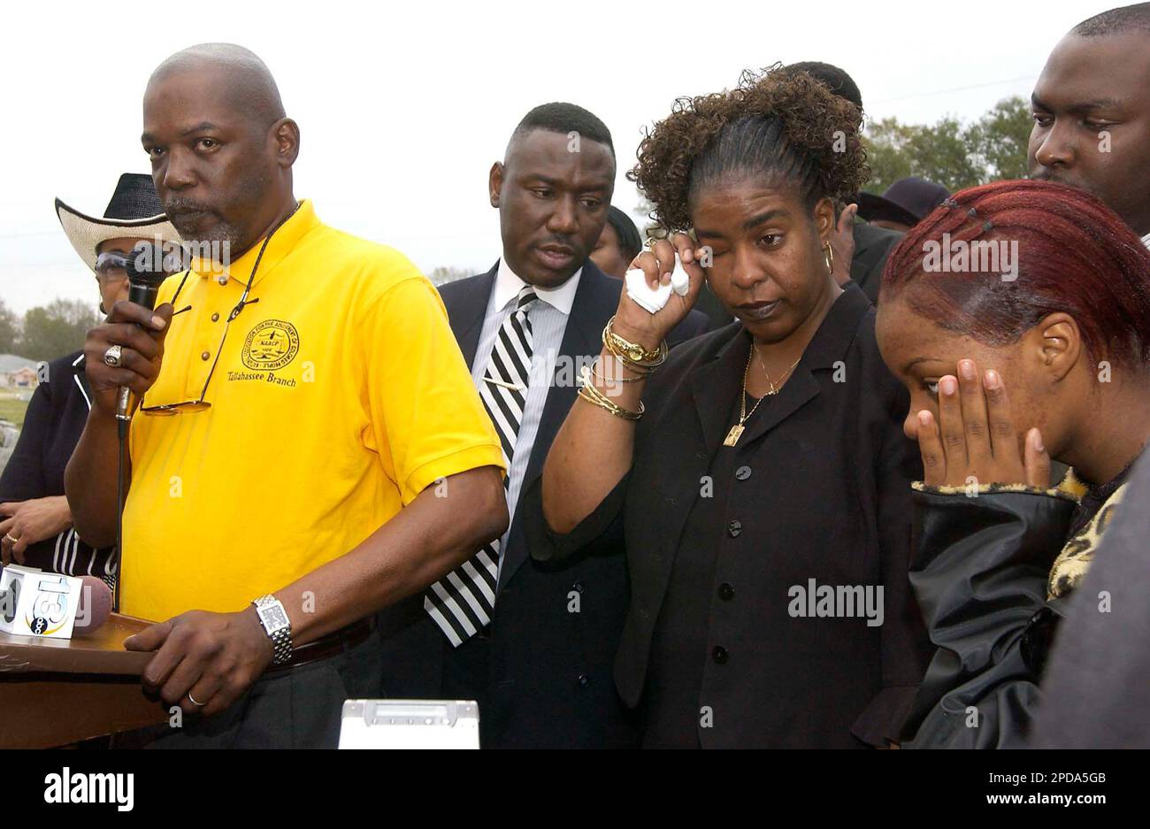 NAACP representative Dale Landry, left, speaks as attorney Benjamin ...