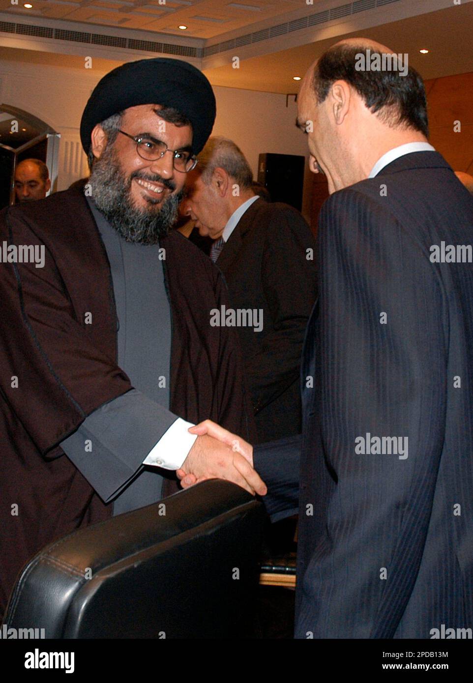 Hezbollah leader Sheik Hasan Nasrallah, left, shakes hands with the ...