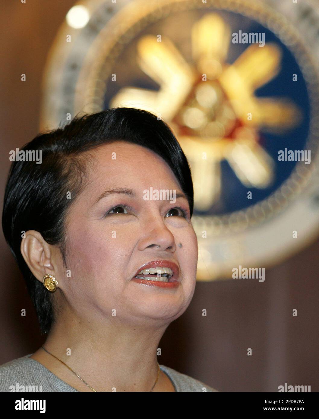 Philippine President Gloria Macapagal Arroyo, reacts during an oath ...