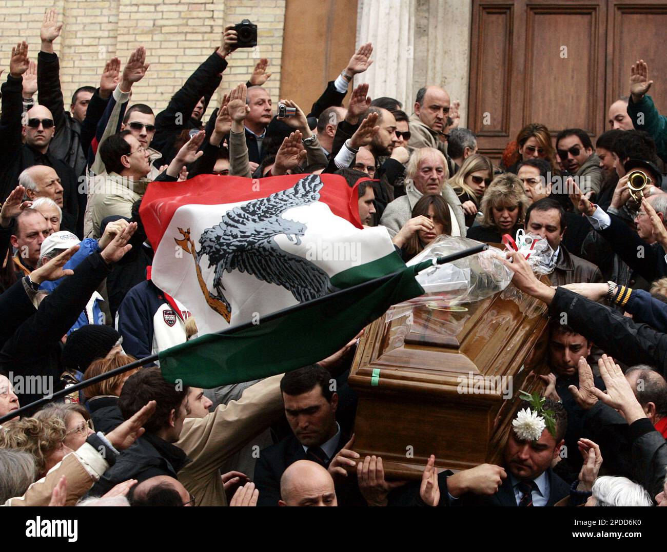 People giving fascist salutes and waving an Italian flag bearing a ...
