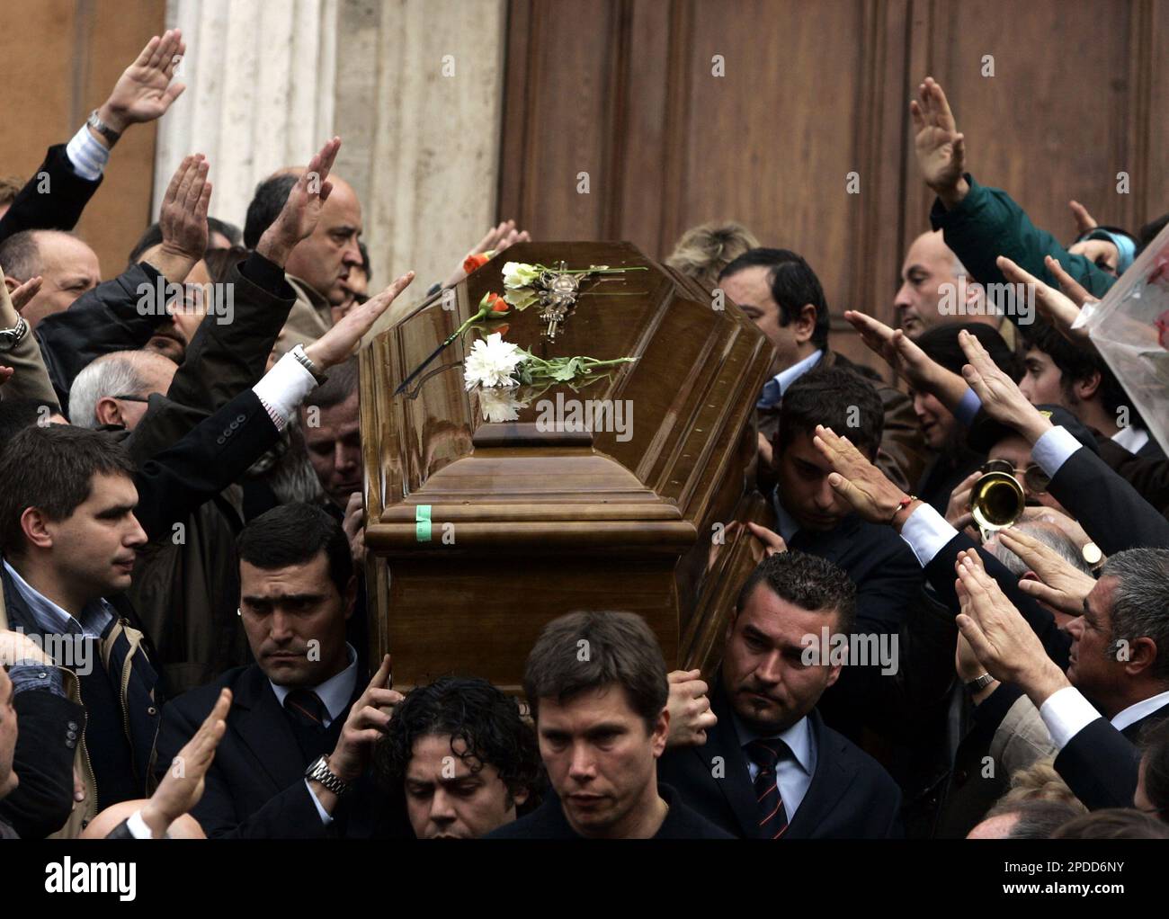 People greet with fascist salutes the coffin of Romano Mussolini ...