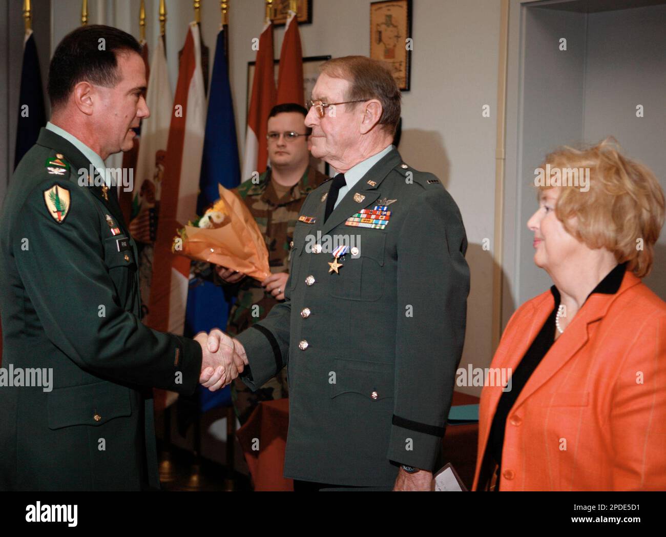 U.S.Col. Michael Ryan, left, congratulates Chief Warrant Officer (ret ...