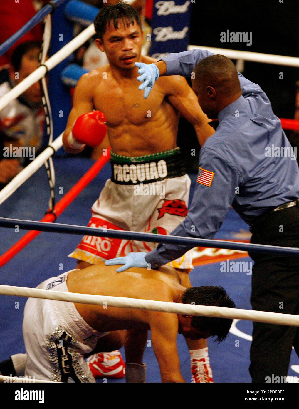 Referee Kenny Bayless, right, stops the super featherweight boxing ...