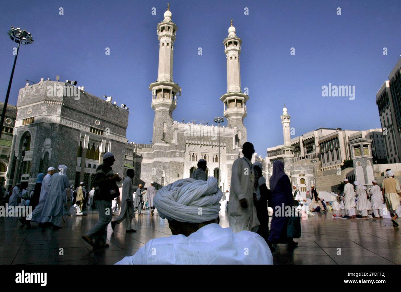 Muslim pilgrims gather outside the Great Mosque in Mecca, Islam's ...