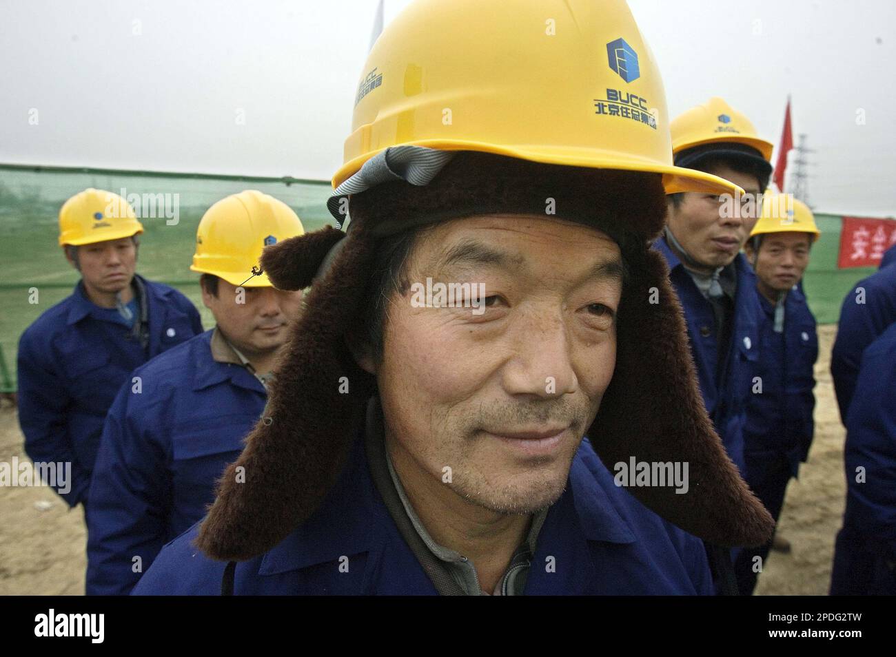 Construction workers attend a groundbreaking ceremony of the hockey and ...