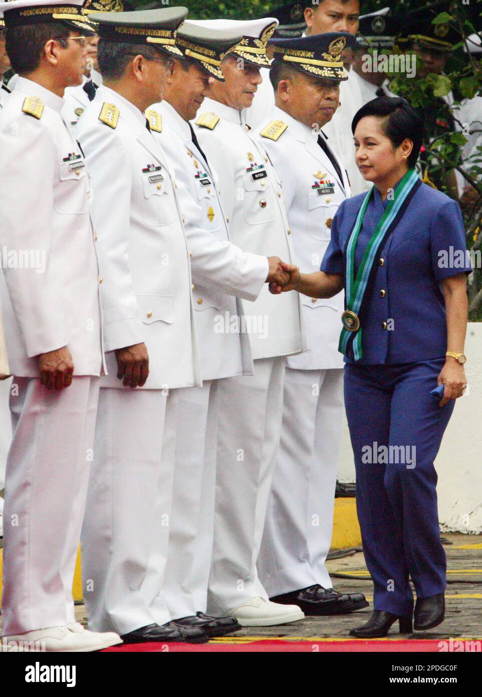 Philippine President Gloria Macapagal Arroyo, right, shakes hands with ...