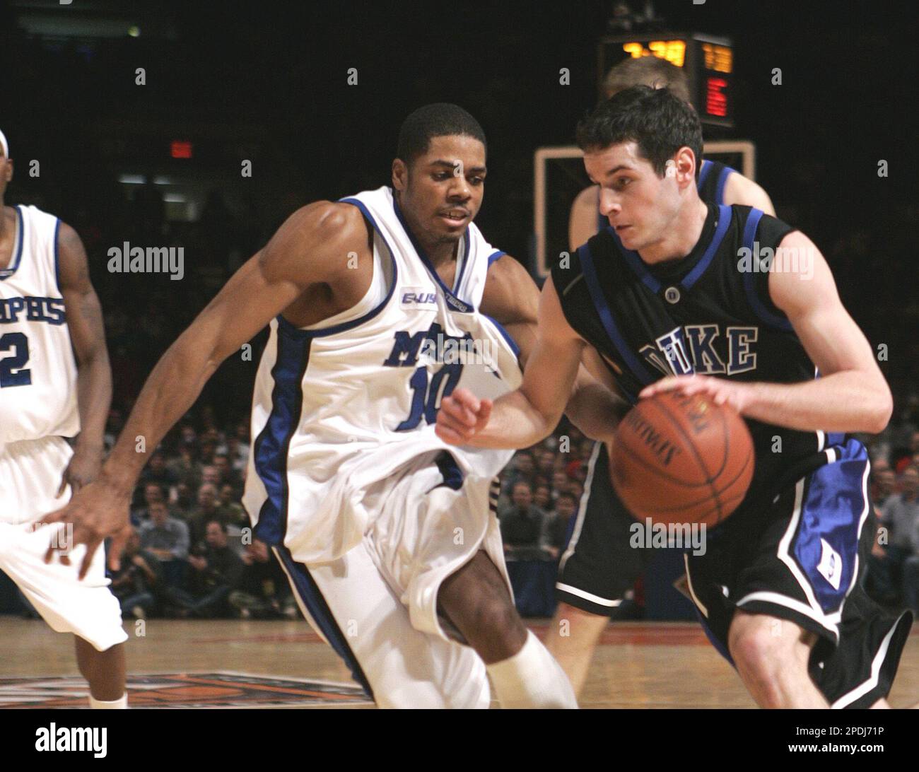Duke's J.J. Redick, right, drives past Memphis' Rodney Carney in the ...