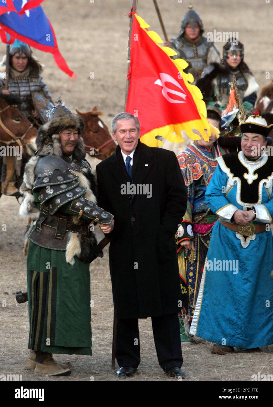 U.S President George W. Bush, center, shakes hands with a Mongolian in ...