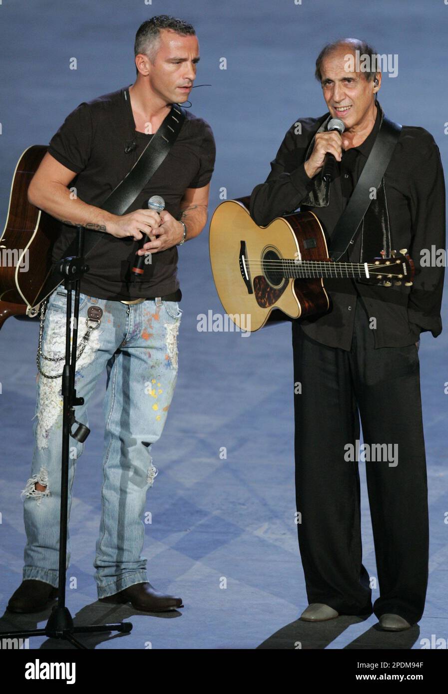 Italian pop star Eros Ramazzotti, left, and TV host Adriano Celentano ...