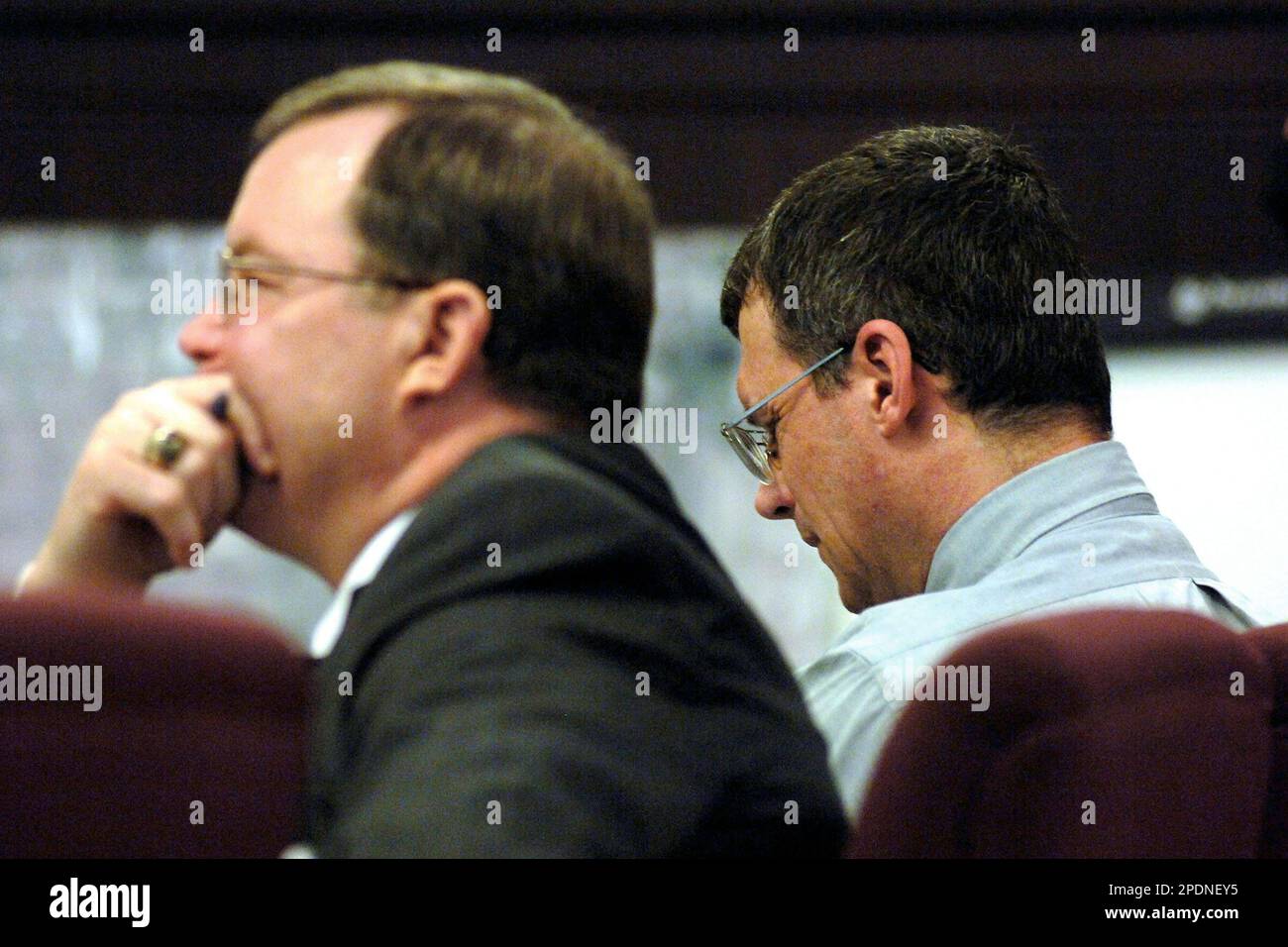 Portage County Public Defender Dennis Day Lager, left, and defendant James Trimble react to ...