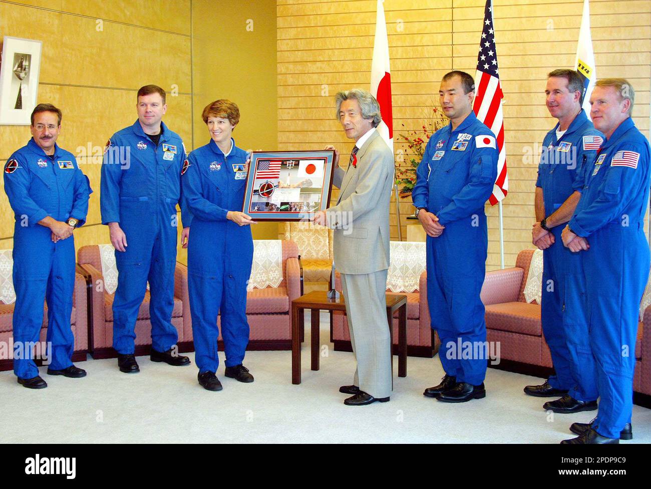 Japanese Prime Minister Junichiro Koizumi, center, receives a photo ...