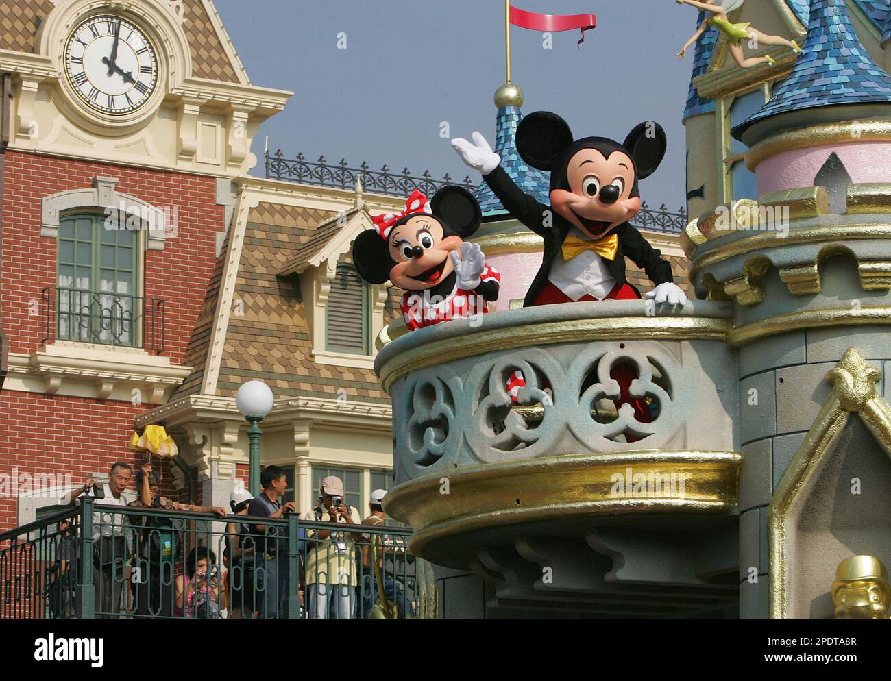 Disney characters Mickey Mouse and Minnie Mouse waves on a float during ...