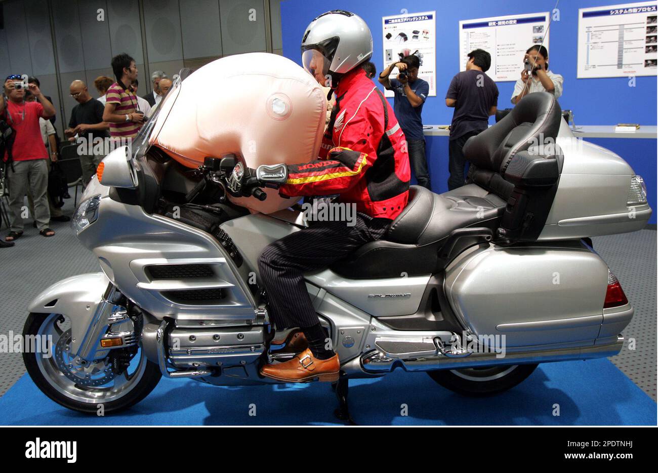 Honda Motor Co., Ltd. staff Takeshi Kuroe poses on Honda's new Gold ...