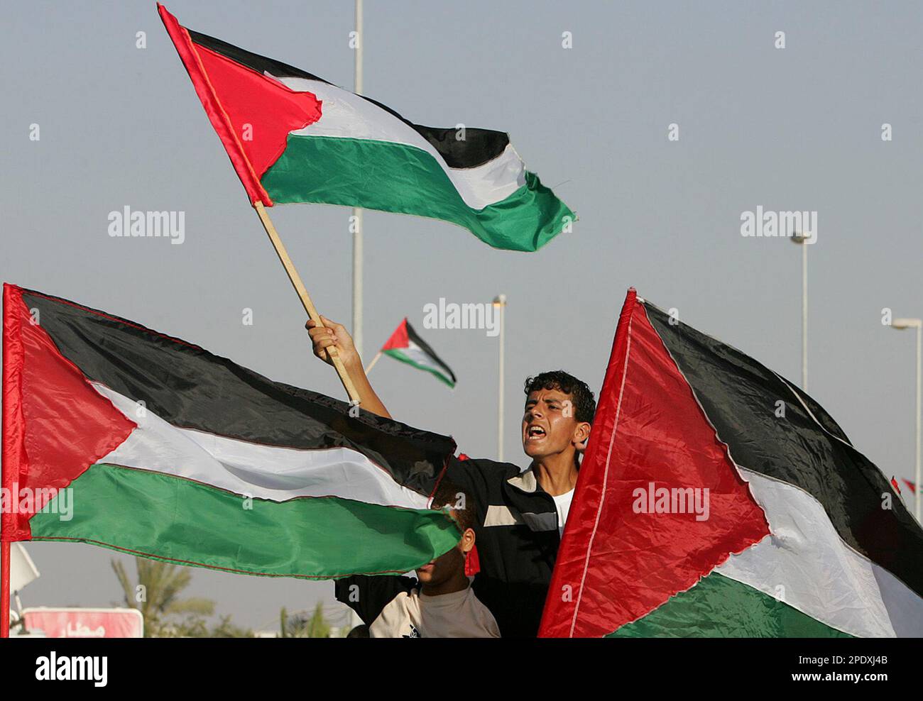 A Palestinain youth waves the Palestinian flag during a celebration of ...