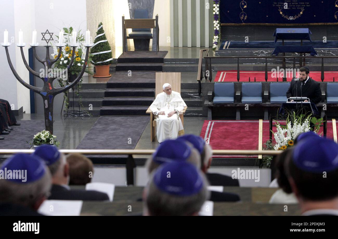Pope Benedict XVI sits next to a Menorah, a Jewish symbol and a ...