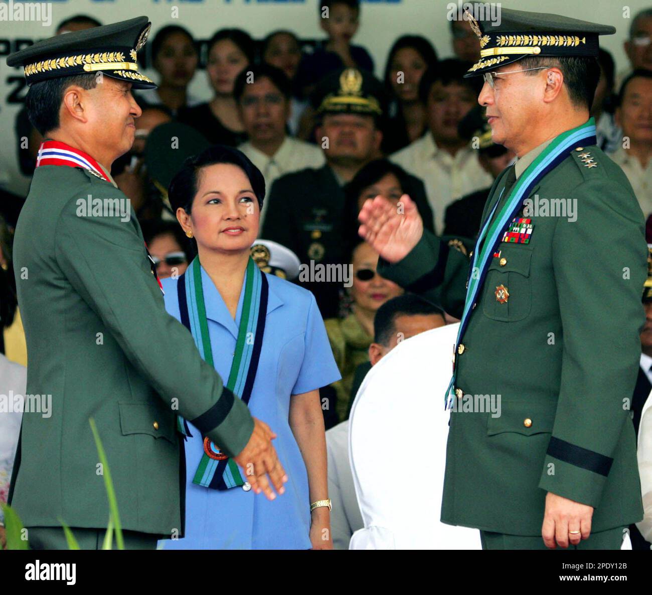 Philippine President Gloria Macapagal Arroyo, center, watches as ...