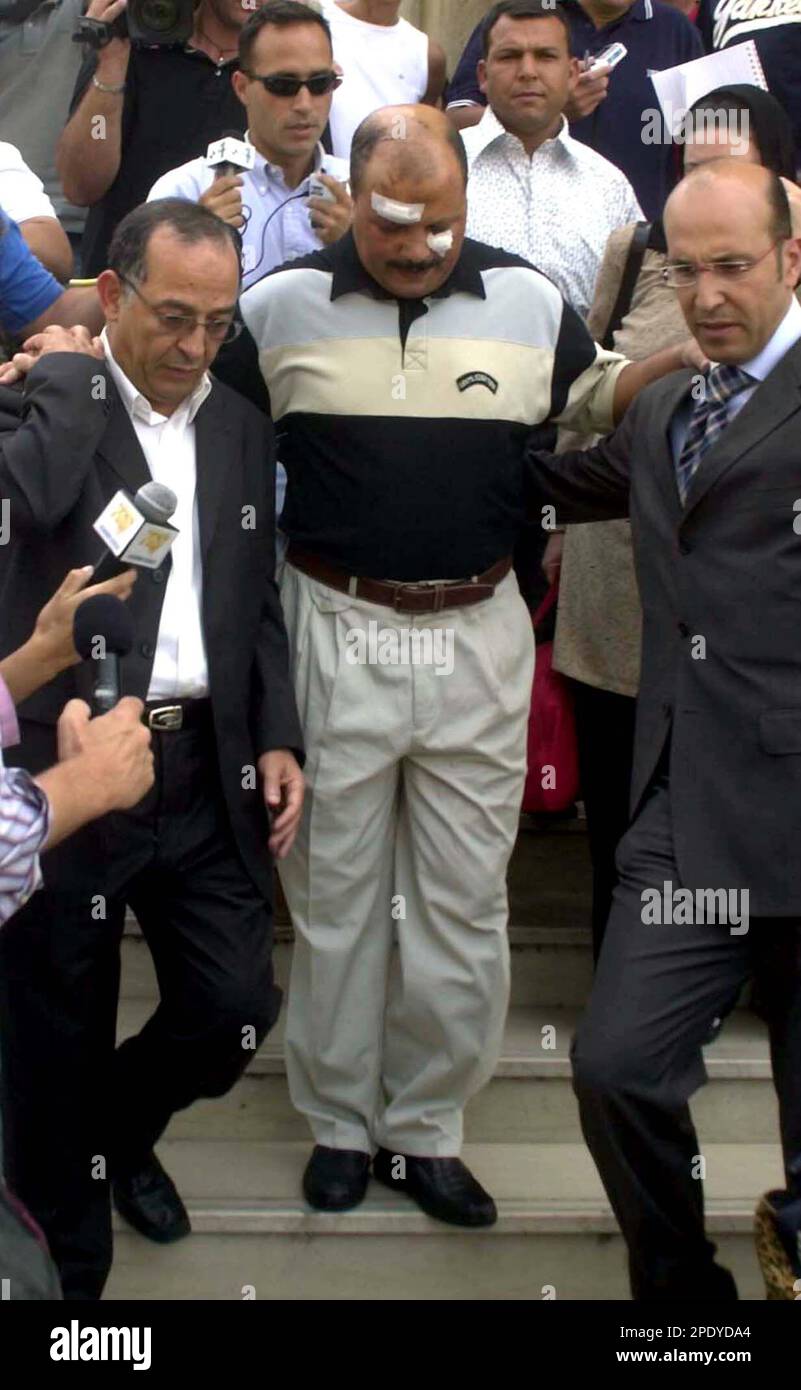 ATR-72 Tuninter pilot Chafik Gharbi,center, is assisted as he leaves ...