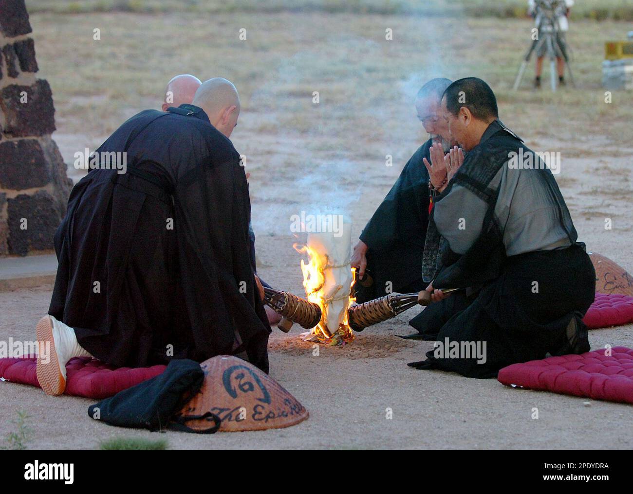 Japanese Buddhist monks use three torches to light a sacred cloth ...