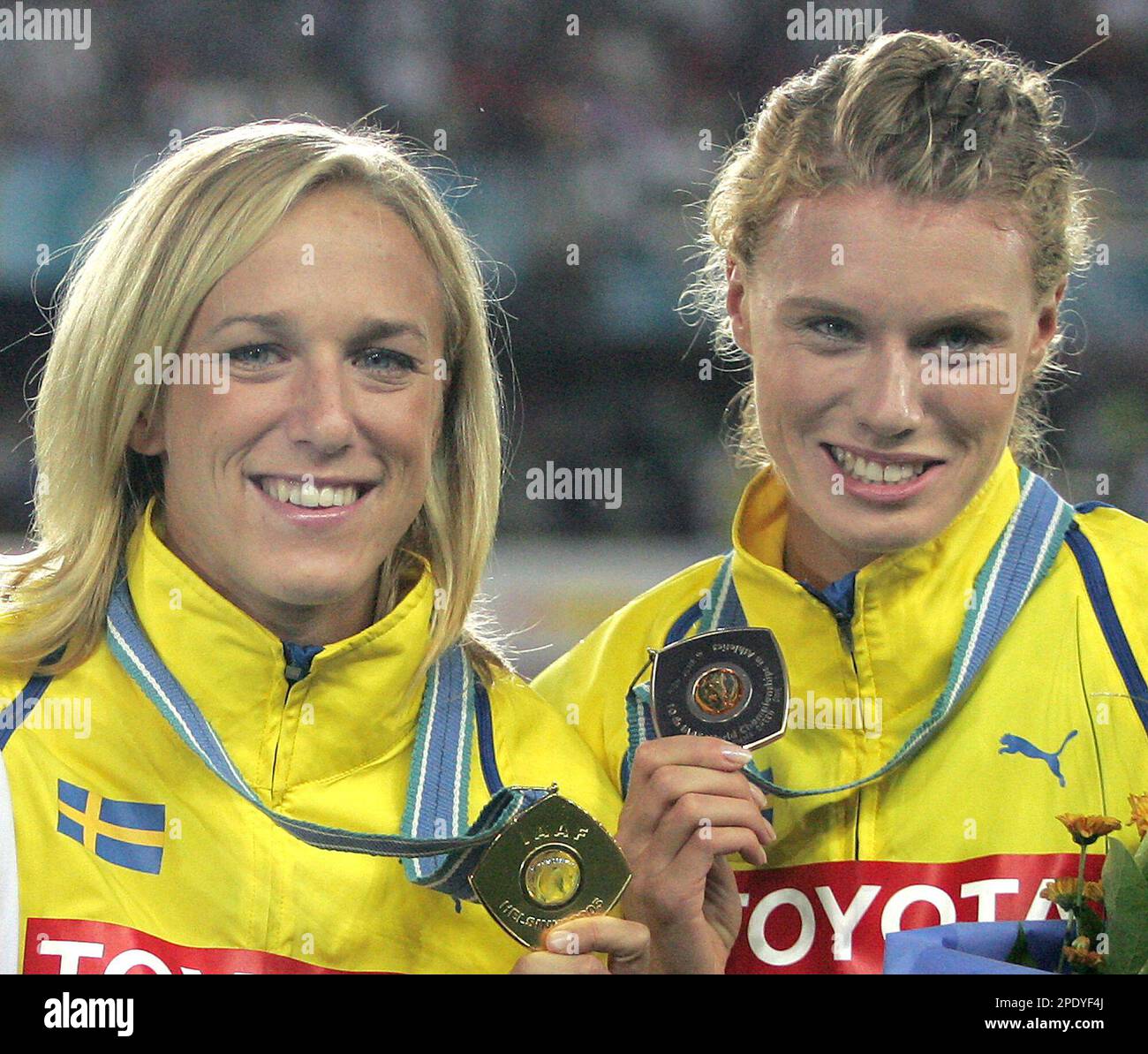 Gold medalist Sweden's Kajsa Bergqvist, left, and her compatriot Emma ...