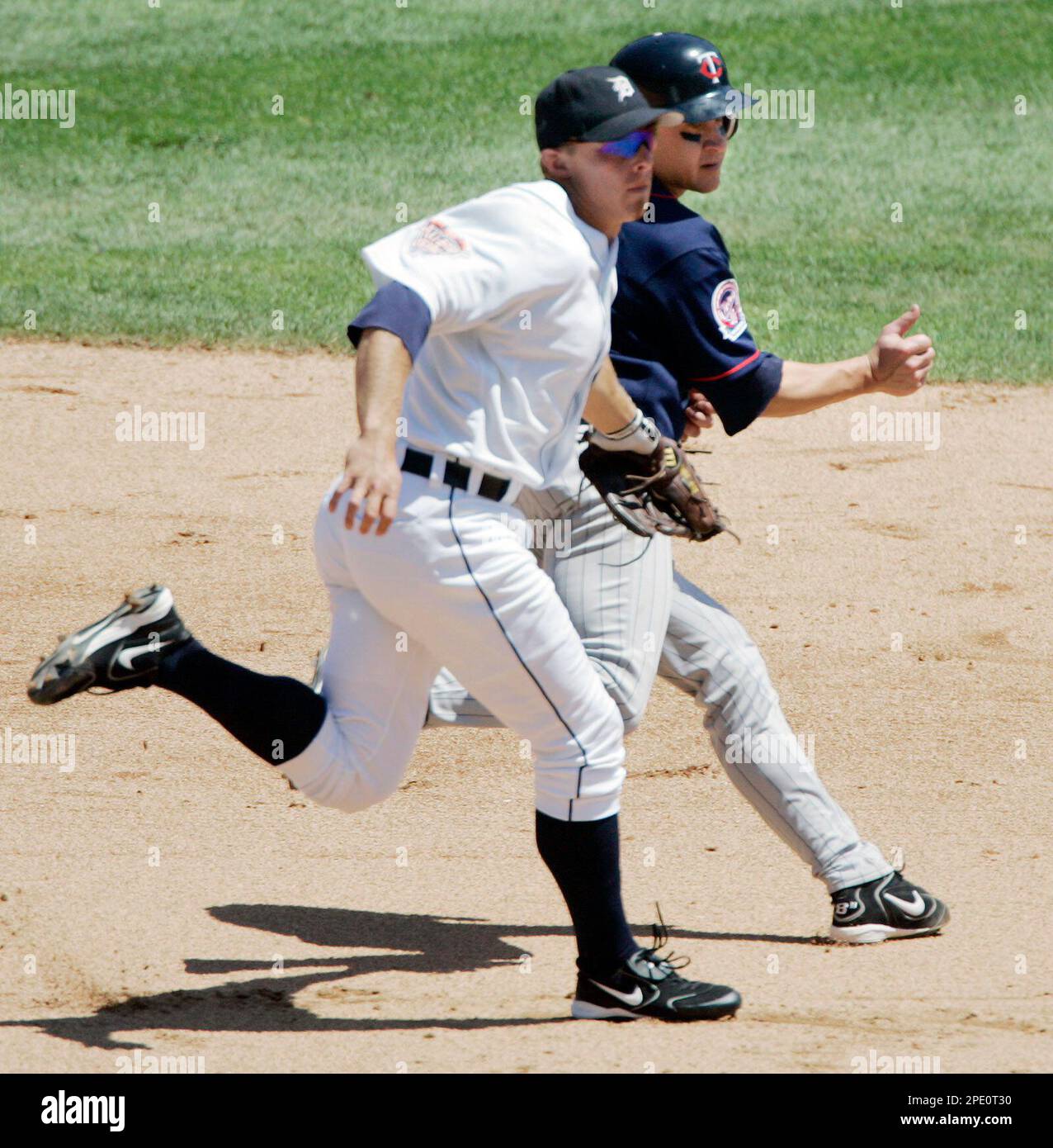 Detroit Tigers third baseman Brandon Inge, left, tags out Minnesota ...