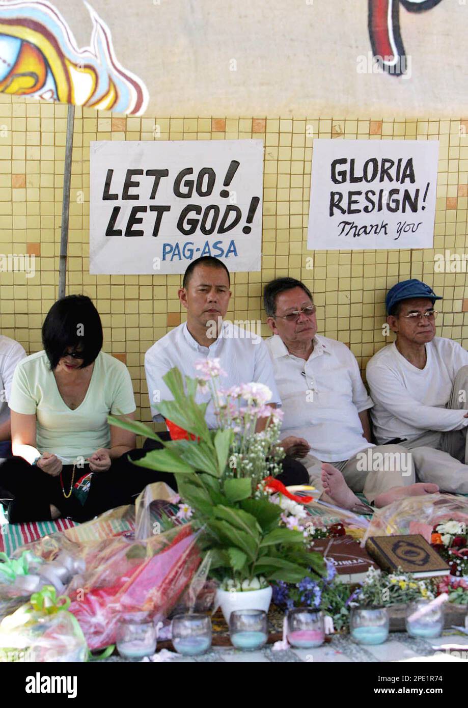 Roman Catholic priest Father Robert Reyes, second left, leads his group ...