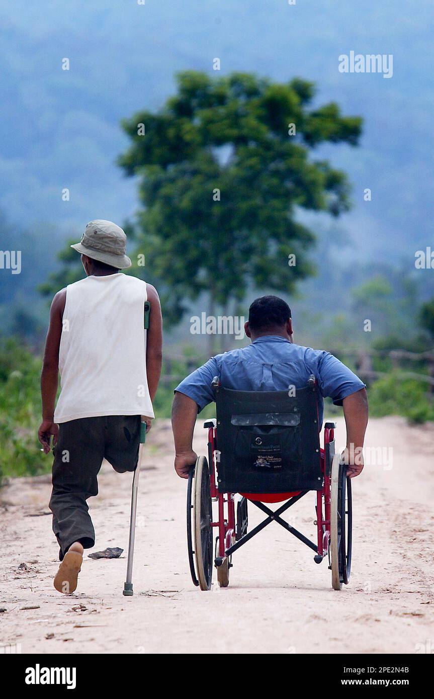 Cambodian landmine victims Keo Vuthy, 43, left, and Sim Sameth, 27 ...