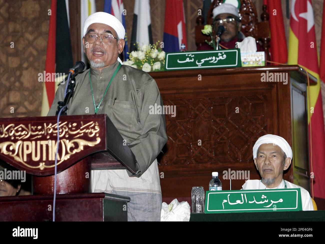 Pan-Malaysian Islamic Party (PAS) President Abdul Hadi Awang, left ...
