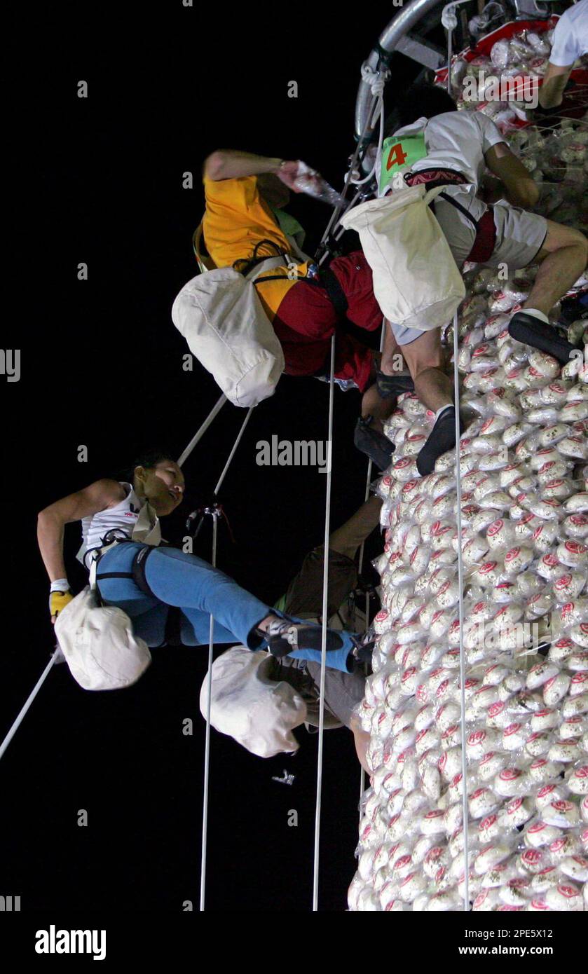 Bun-snatchers climb over a a sturdier 14 meter-tall (46 feet) bun tower ...