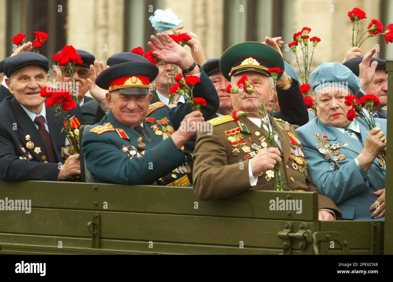 Russian WWII veterans ride mock Soviet WWII military trucks along the ...