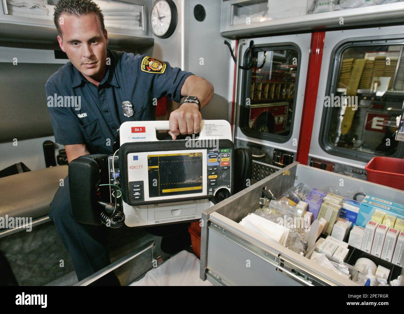 Los Angeles Fire Department paramedic Damon Leach holds a defibrillator ...