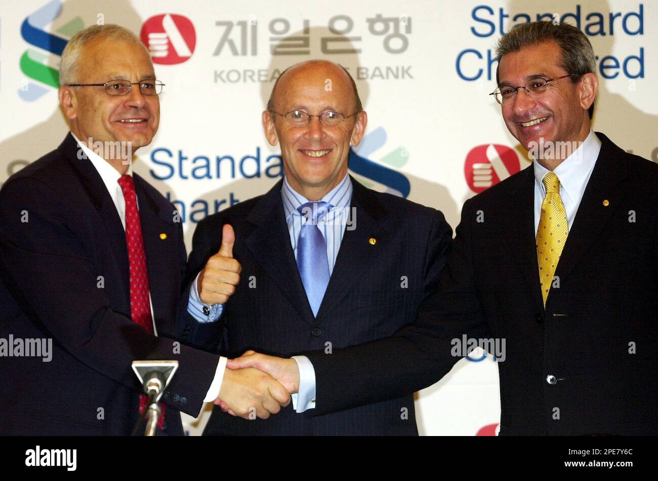 Standard Chartered Group Chief Executive Mervyn Davies, center, poses ...