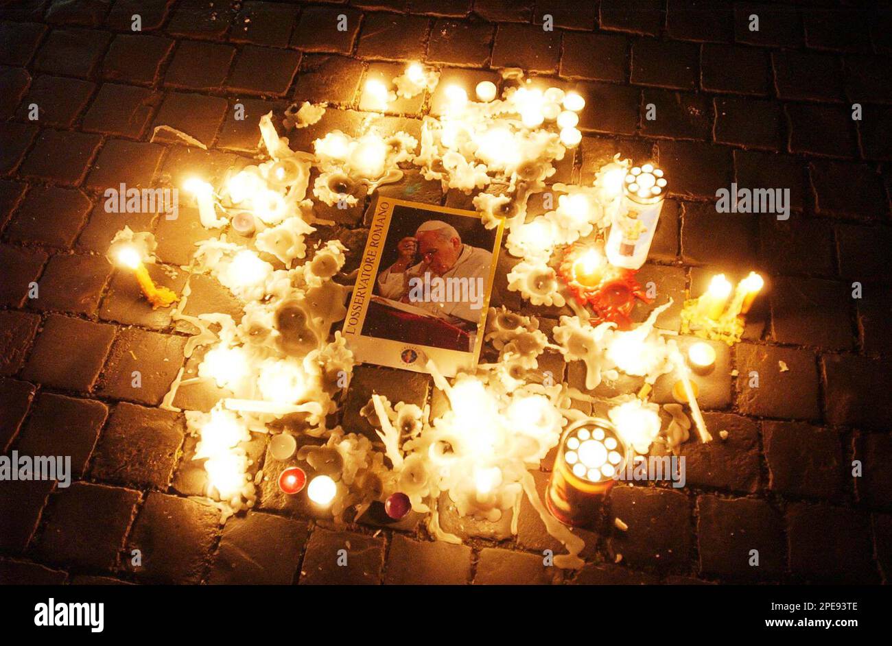 Candles surround an image of Pope John Paul II during a vigil in St ...