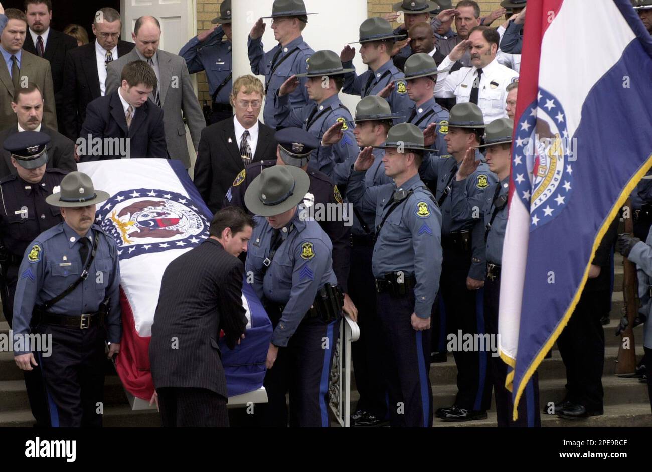 Members of the Missouri State Highway Patrol salute the body of fellow ...