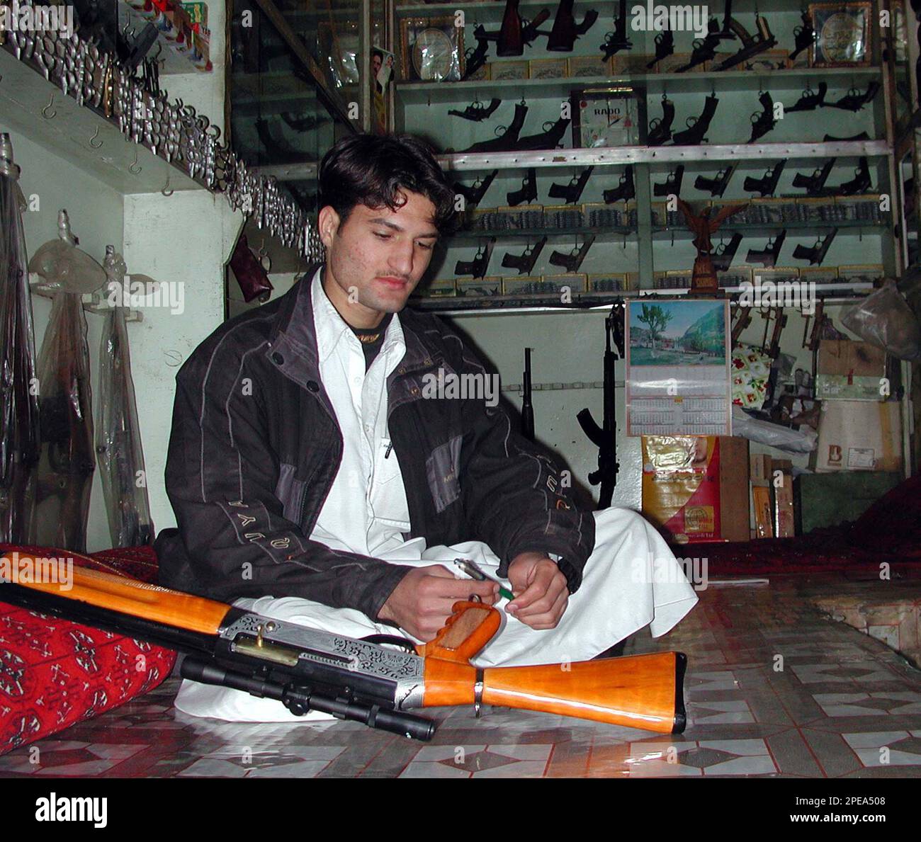 Pakistani student from tribal area Dilnawaz Khan, 16, holds local-made ...