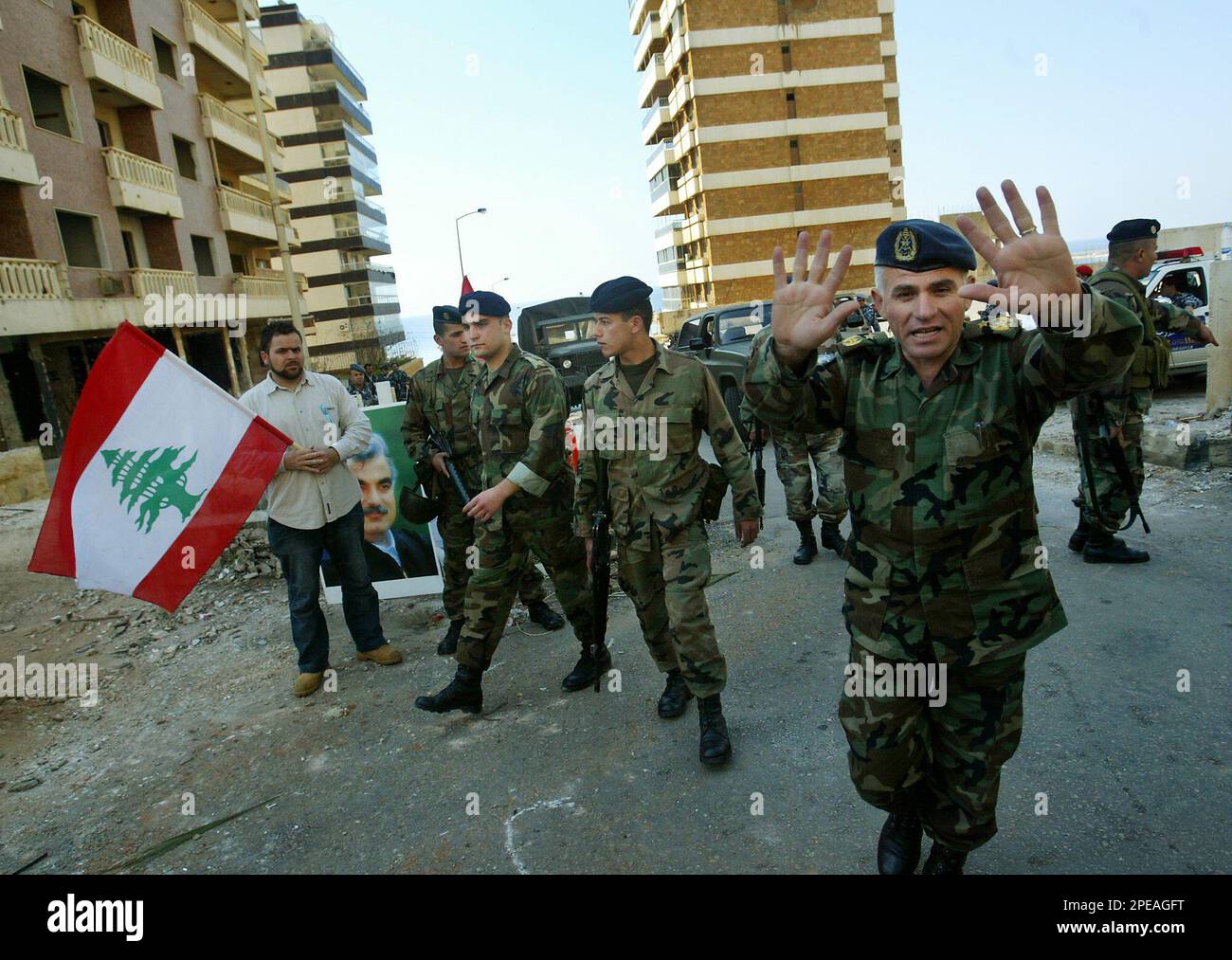 A Lebanese Army officer gestures for people to get back as they secure ...