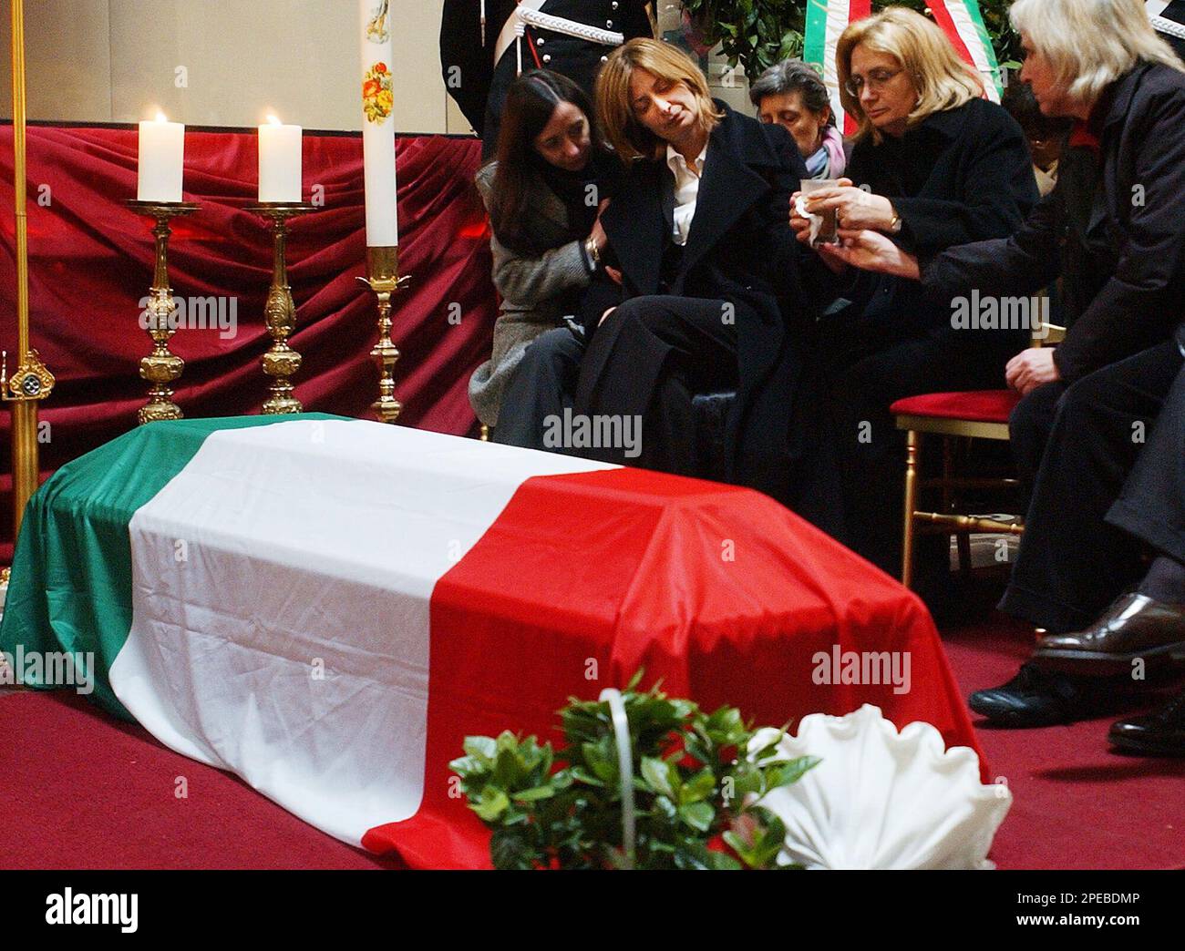 Second from left, Rosa Maria Calipari sits beside the coffin of her ...